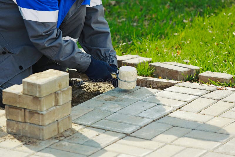 Bricklayer Lays Paving Slabs Outside. Working Man Performs Landscaping ...