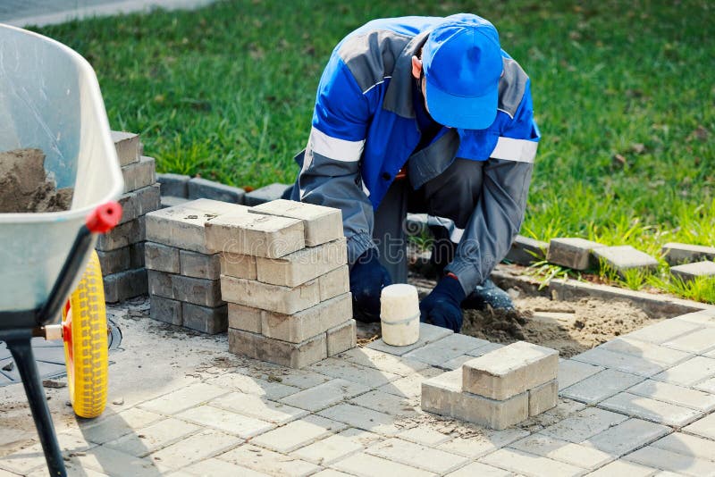 Bricklayer Lays Paving Slabs Outside. Working Man Performs Landscaping ...