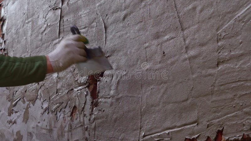 A Bricklayer Levels the Plaster on a Brick Wall with a Spatula ...
