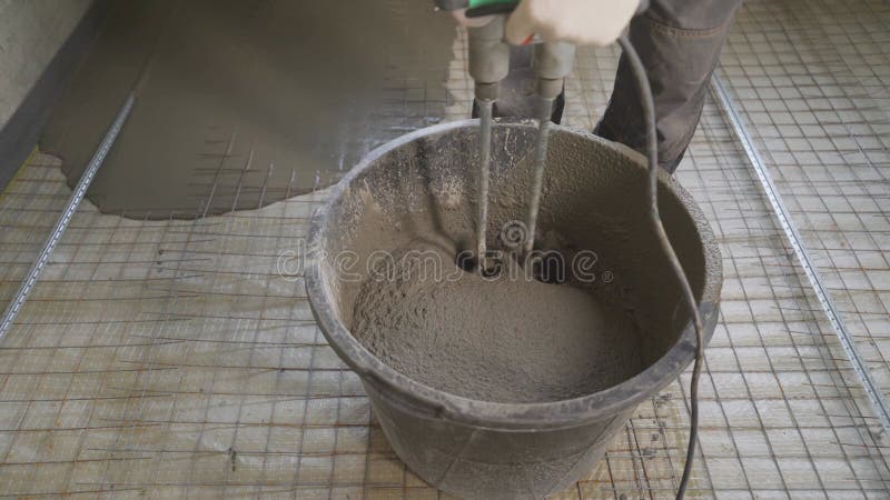 Bricklayer Mixes Cement in a Bucket. the Process of Filling the Floor ...