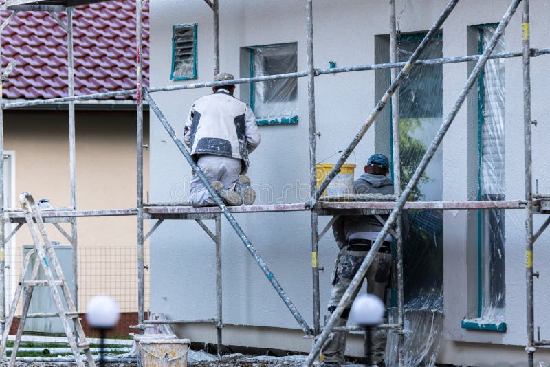 Bricklayer Plastering a Wall with Plaster Next To an Electrical ...
