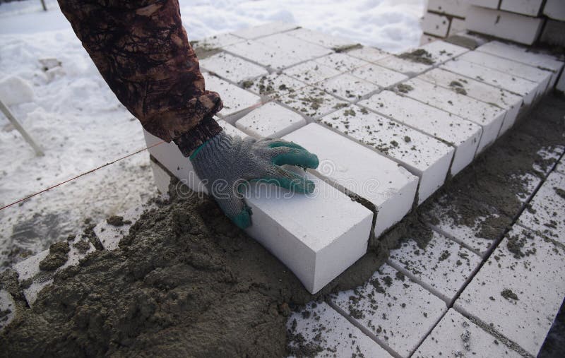 A Bricklayer Puts Bricks in Cement. Stock Photo - Image of hand, builds ...