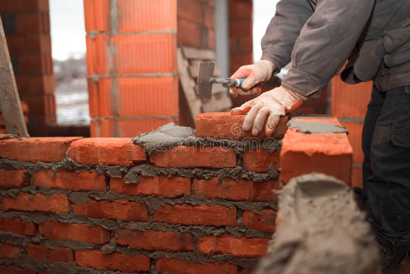 Bricklayer Puts Bricks To Make a Wall Stock Image - Image of pouring ...