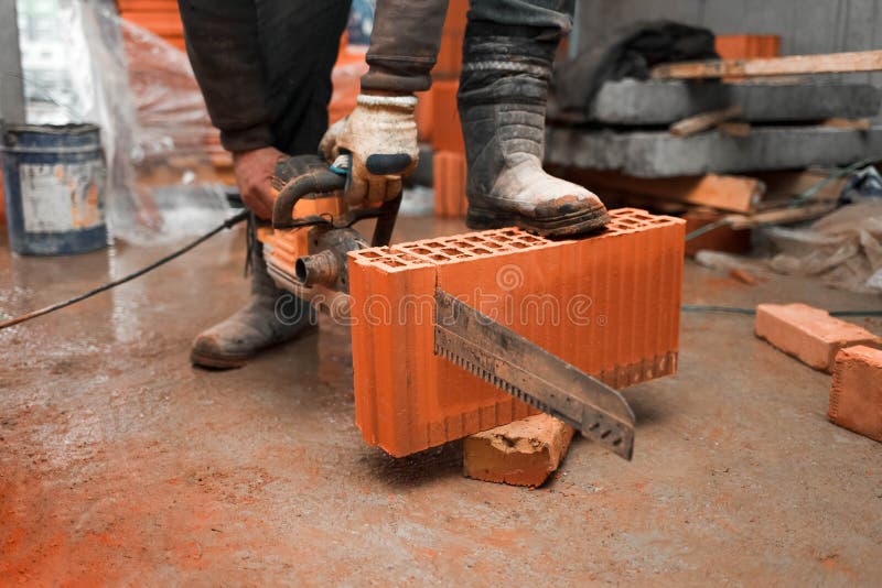 Construction Worker Cuts a Brick with a Saw Stock Image - Image of ...