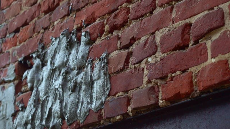 A Bricklayer Puts Plaster on a Brick Wall. Plastering Cement at Wall ...