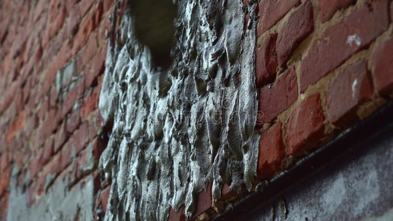 A Bricklayer Puts Plaster on a Brick Wall. Plastering Cement at Wall ...