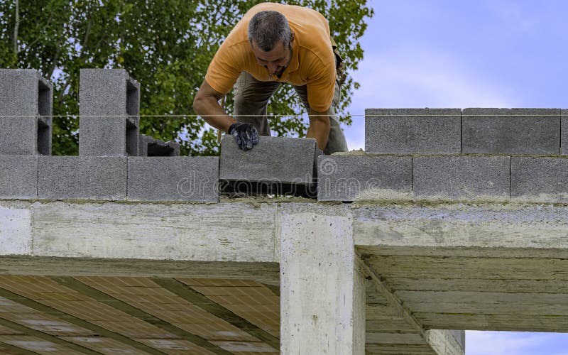 Bricklayer Putting Down Another Row of Bricks in Site Stock Photo ...
