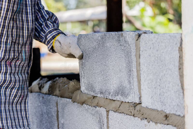 Bricklayer Putting Down Another Row of Bricks in Site. Stock Photo ...