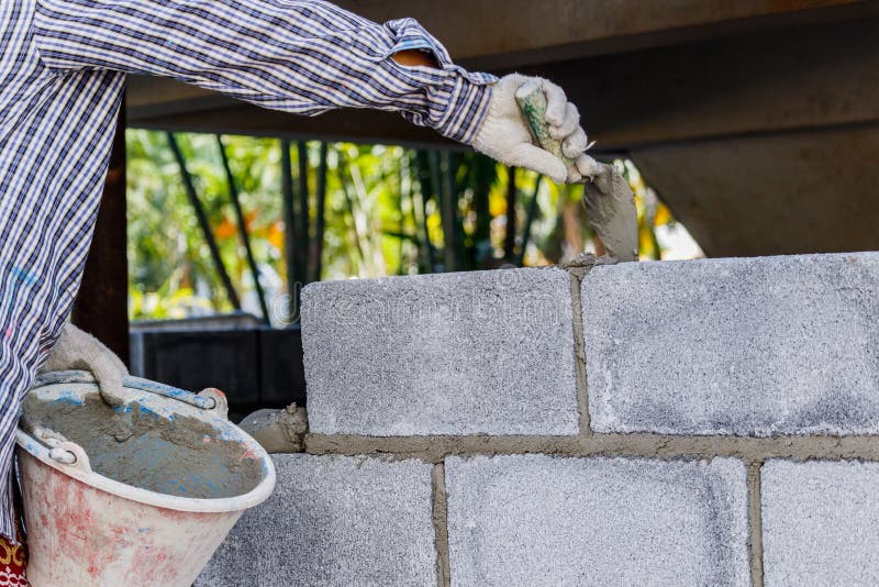 Bricklayer Putting Down Another Row of Bricks in Site. Stock Photo ...