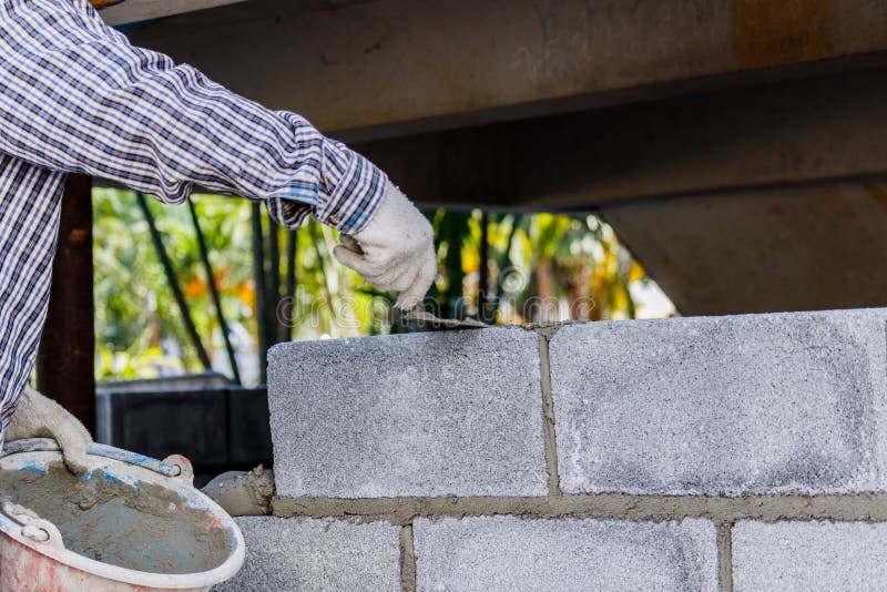 Bricklayer Putting Down Another Row of Bricks in Site. Stock Photo ...