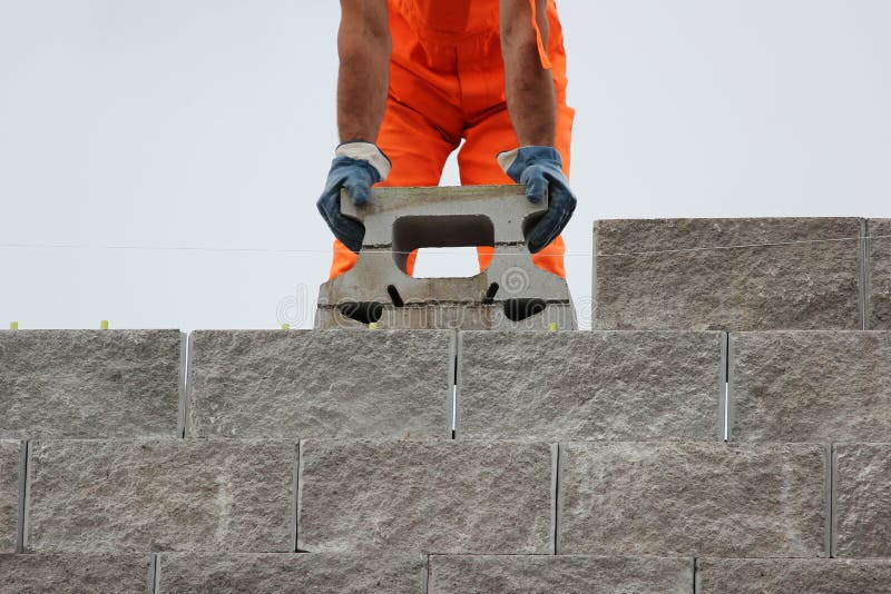 Bricklayer Putting Down Another Row of Bricks in Site during the ...