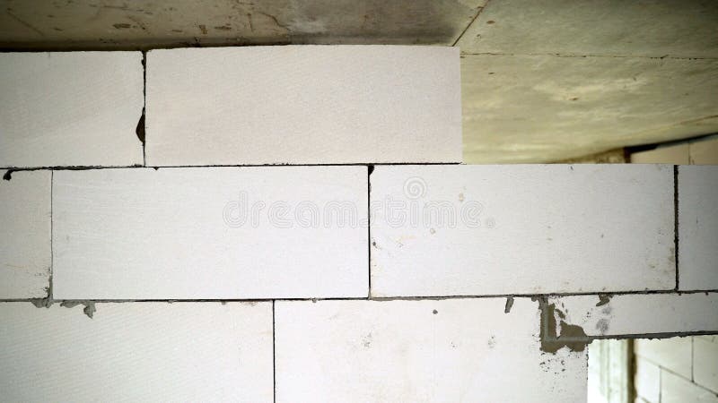 A Bricklayer Sets Up a Masonry Block Wall. Construction of Interior ...
