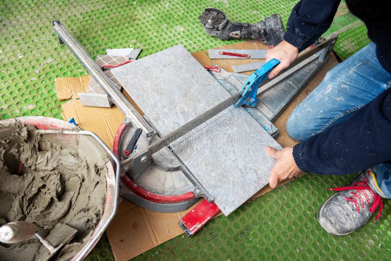 Tiler at Work Installing New Floor with Tiles. Construction Stock Image ...