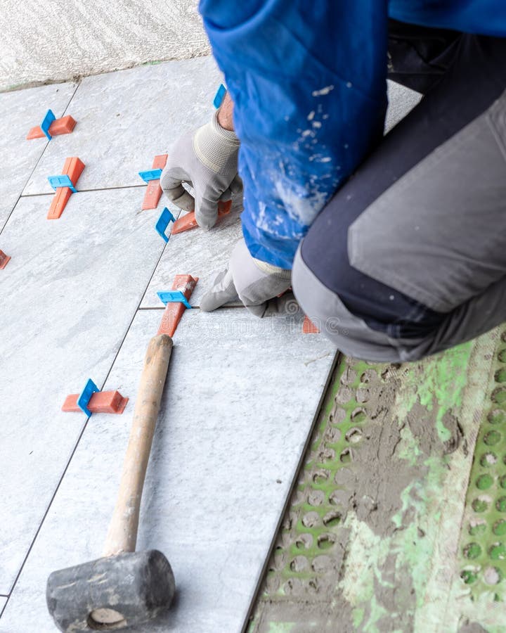 Tiler at Work Installing New Floor with Tiles. Construction Stock Image ...