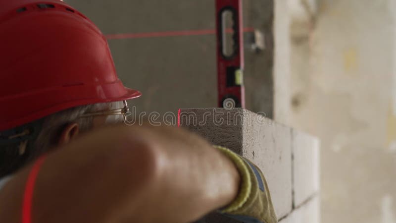 Bricklayer Using Spirit Bubble and Laser Level To Precise Check ...