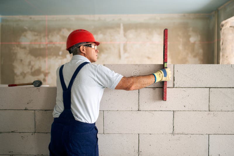 Bricklayer Using Spirit Bubble and Laser Level To Precise Check ...