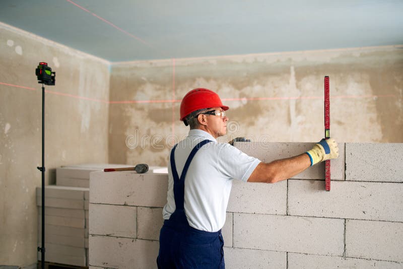 Bricklayer Using Spirit Bubble and Laser Level To Precise Check ...