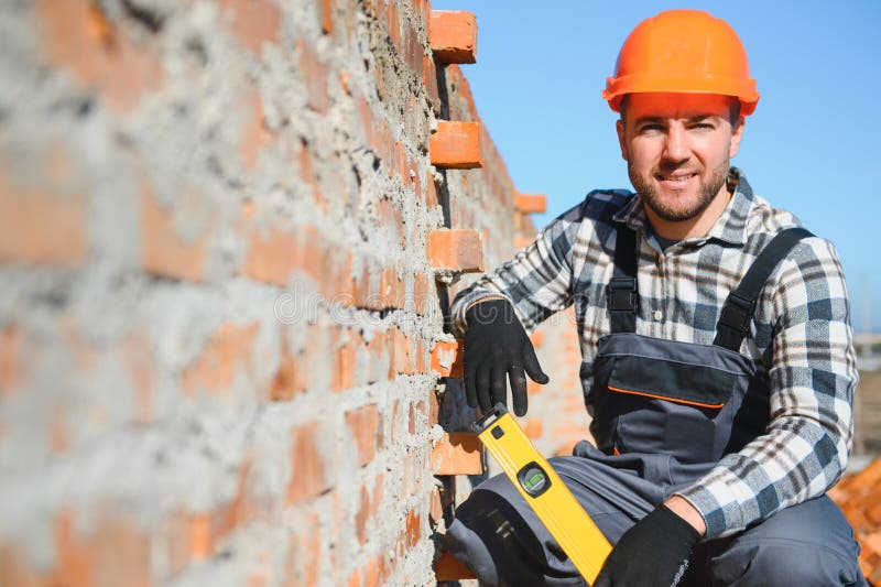 Bricklayer Using a Spirit Level To Check New Red Brick Wall Outdoor ...