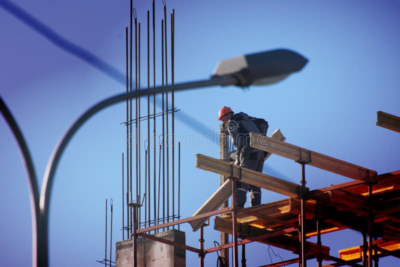 A Bricklayer Worker Erects a Wall on the Construction of a Multi-storey ...
