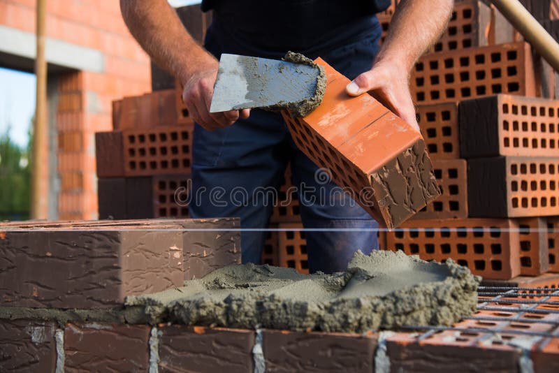 Bricklayer Worker Installing Brick Masonry on Exterior Wall Stock Image ...