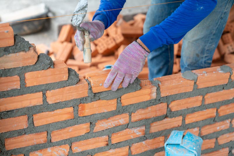 Bricklayer Worker Installing Brick Masonry on Interior Wall with Trowel ...