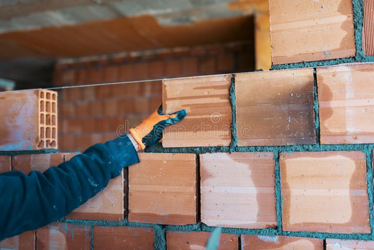 Bricklayer Worker Installing Bricks on Construction Site Stock Photo ...