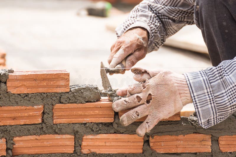 Bricklayer Working in Construction Site of a Brick Wall Stock Image ...