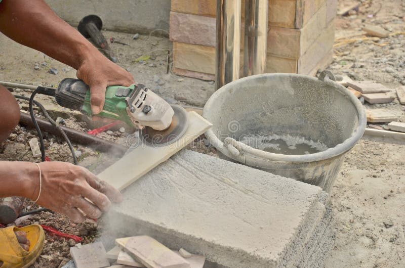 A Bricklayer is Working with Grinding Machine Stock Image - Image of ...