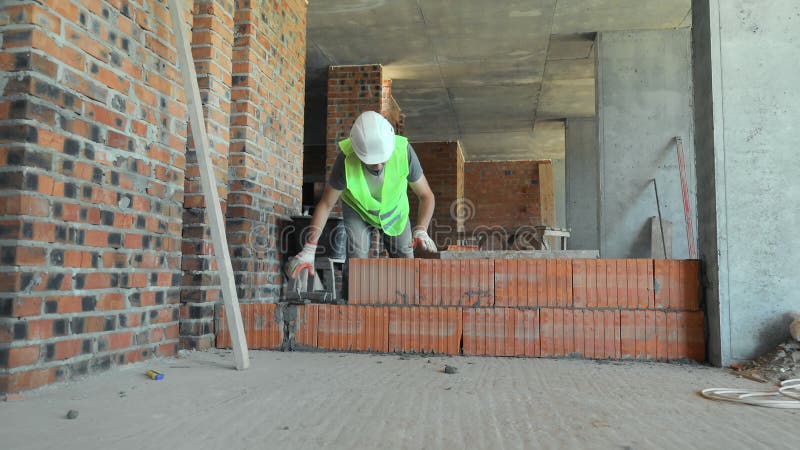 Bricklayer Working on Interior Wall Construction. a Bricklayer, Dressed ...