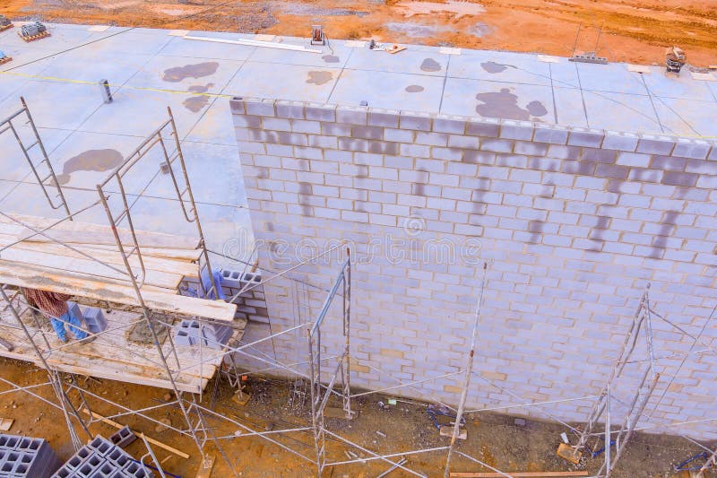 Bricklayers Build Concrete Walls Using Concrete Blocks while Standing ...