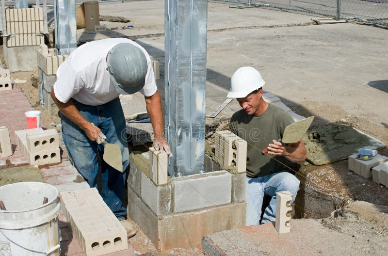 Bricklayers Installing Soldiers Stock Photo - Image of middle, build ...