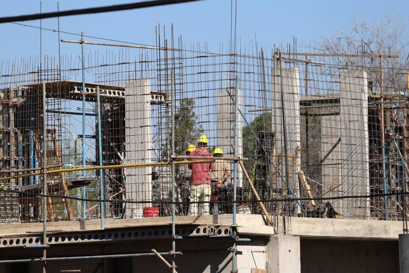 Bricklayers Working on a Building Under Construction. Real Estate Development Concept, Workers ...