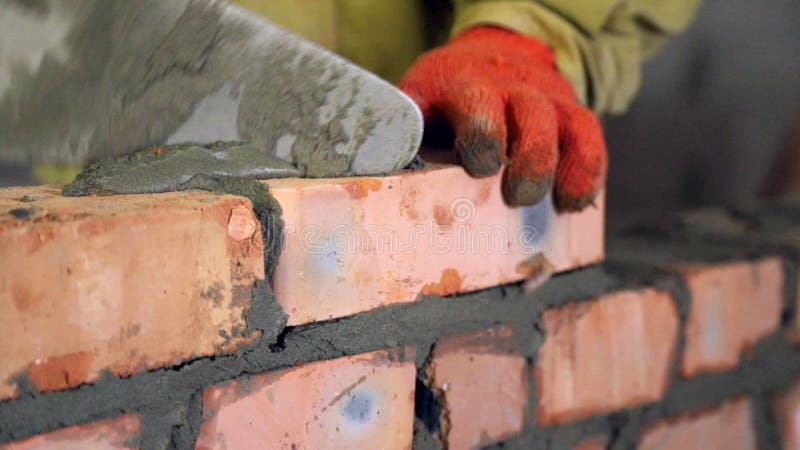 Bricklaying. Hands that Put a Brick on a Construction Site Stock Video ...