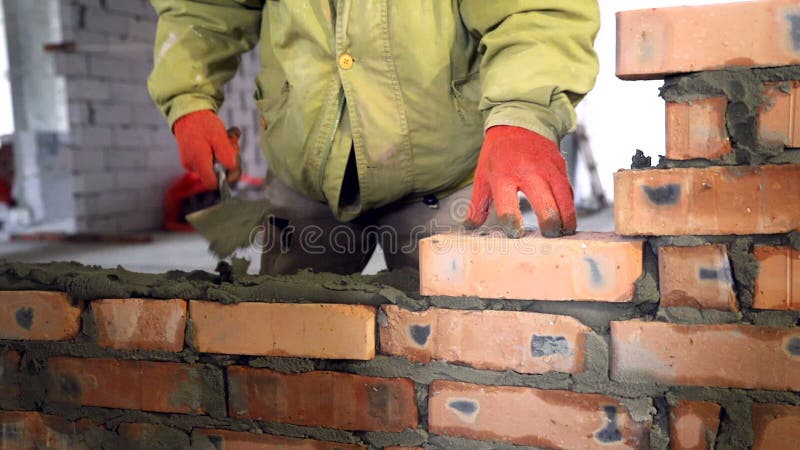 Bricklaying. Hands that Put a Brick on a Construction Site Stock Video ...