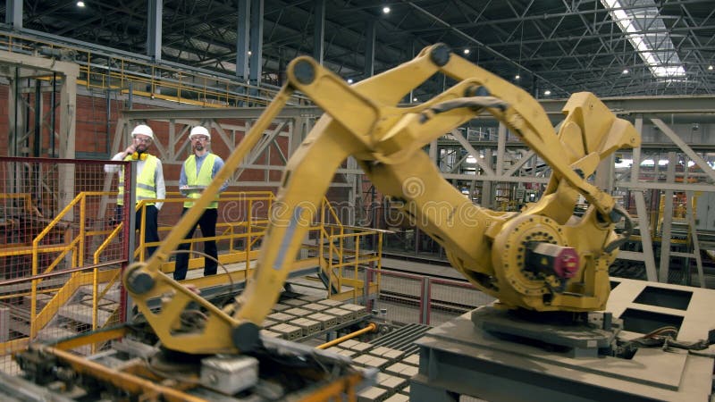 Bricks-loading Unit with Male Workers Observing the Equipment Stock ...