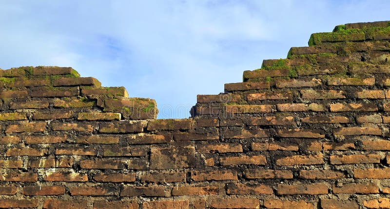 The Bricks Wall is Crumbling and Moss-covered Stock Image - Image of ...