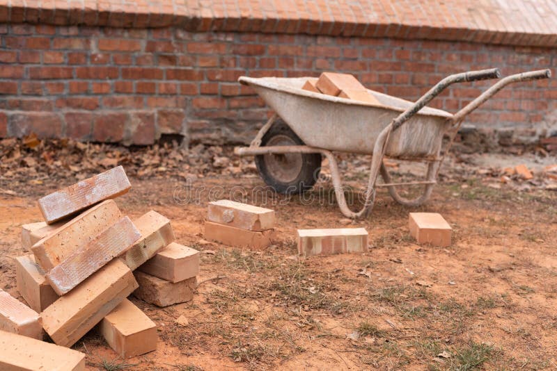 Bricks in a wheelbarrow stock photo. Image of cubes - 165097294