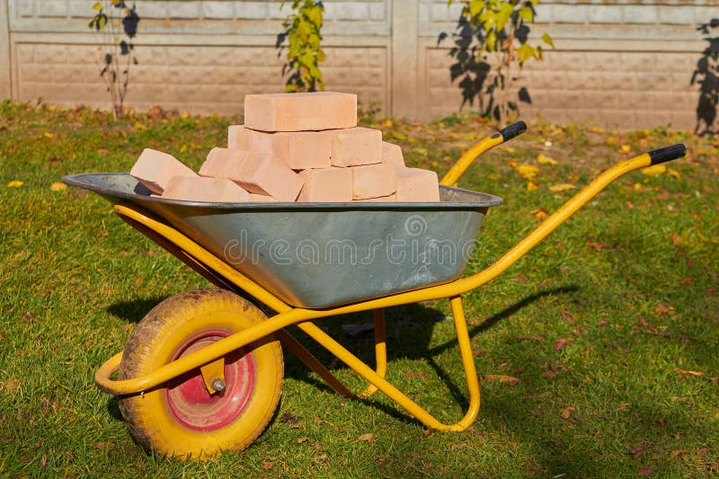 Bricks in Wheelbarrow, a Wheelbarrow with Bricks Stands on the Grass on ...