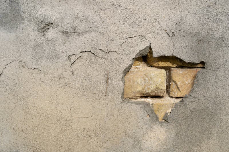 Brickwork is Visible through Hole in Plaster on Gray Wall. Abstract ...
