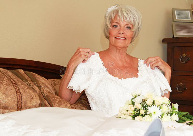 Older Bride and Groom Hands and Rings with Flowers Stock Image - Image ...