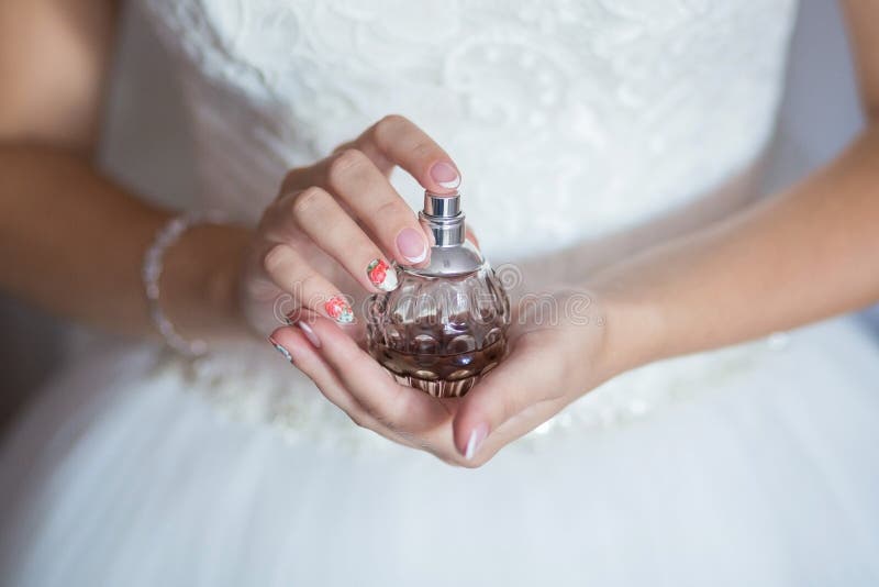 Bride applying perfume stock photo. Image of fragrant - 61750318