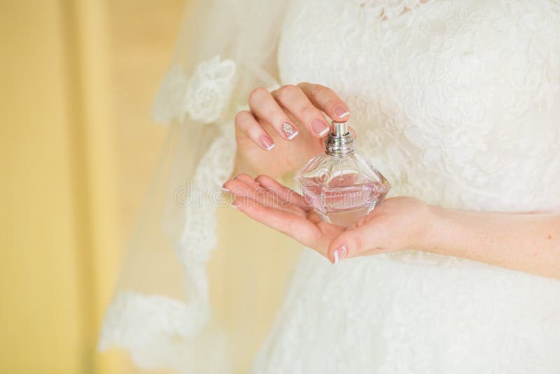 Bride applying perfume stock image. Image of luxury, cosmetics - 66419597