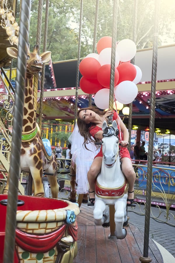 Bride with Balloons Rides on the Carousel Stock Photo - Image of ...