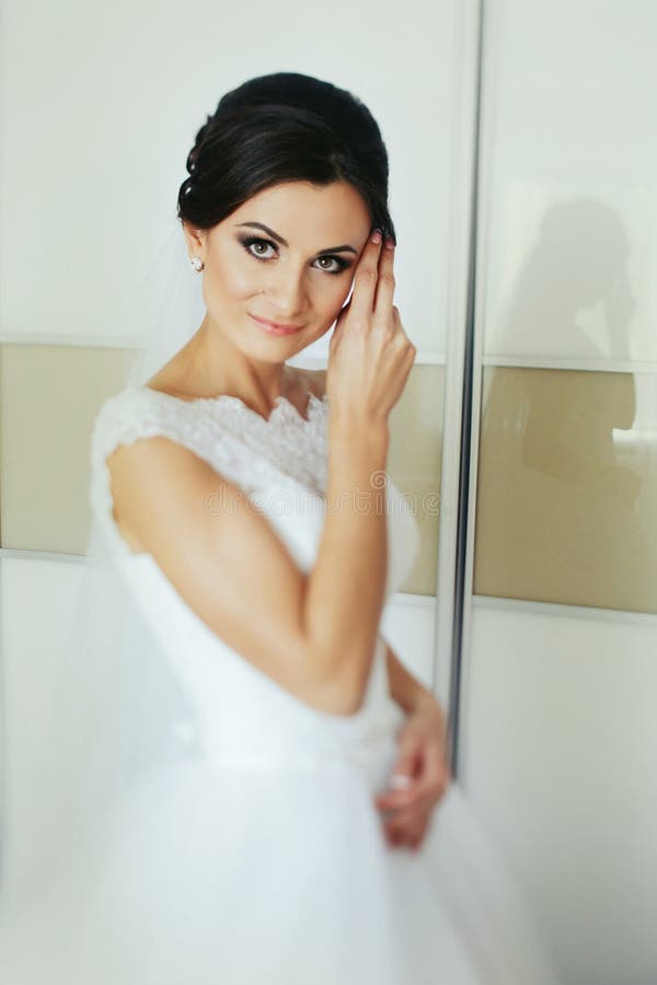 Bride with Big Deep Eyes Poses in a White Room Stock Image - Image of ...