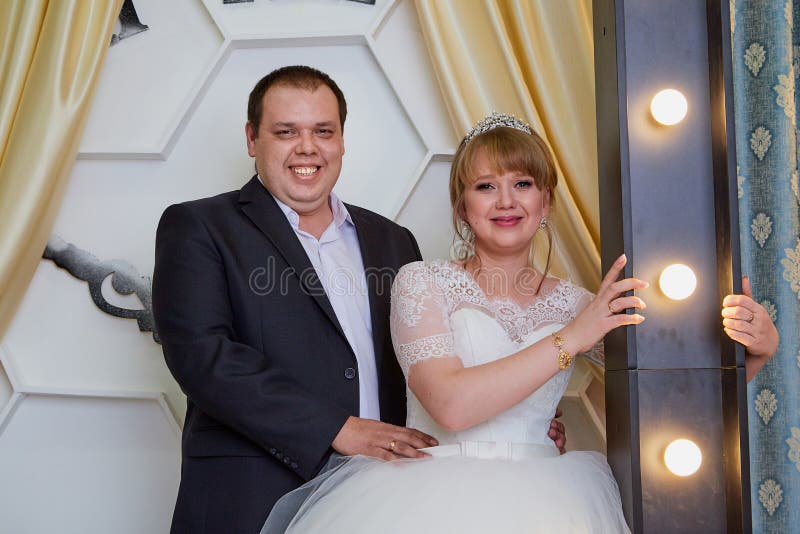 Bride and Big Fat Groom in a Nice Room Stock Photo - Image of bouquet ...