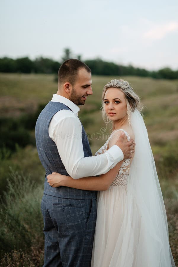 Bride Blonde Girl and Groom in a Field Stock Photo - Image of nature ...