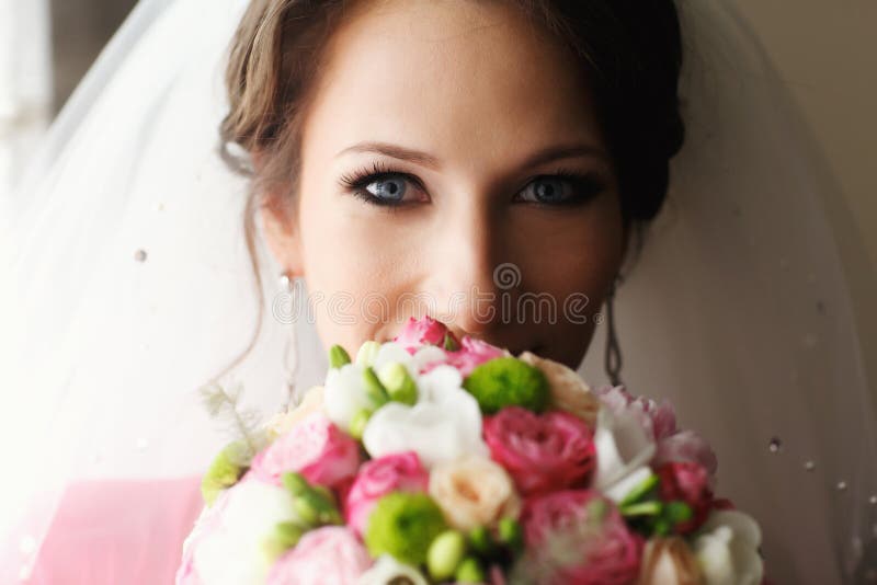 Bride with Blue Eyes Looks Above the Bouquet Stock Photo - Image of ...