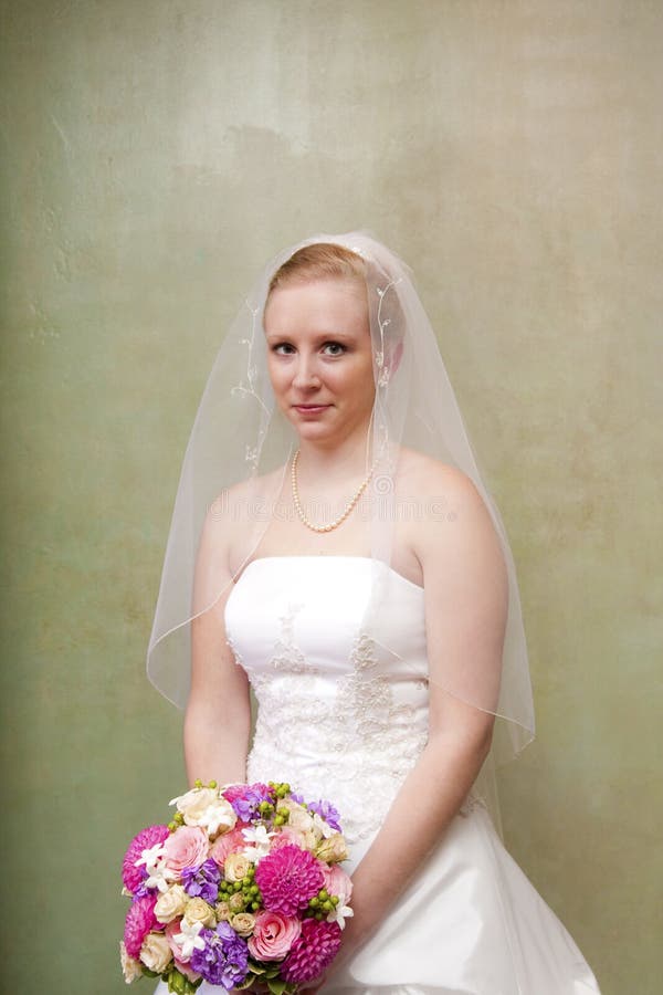 Bride with Bouquet Looking at Camera Stock Image - Image of veil ...