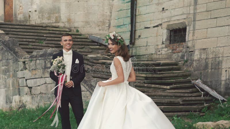 The Bride Coming To Groom, Falling on His Hands and Looking on Camera ...