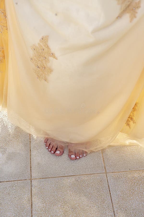 Bride with the Dress Showing Her Bare Feet with White Nails. Stock ...